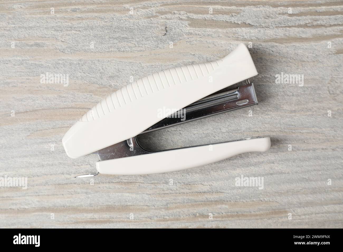 One white stapler on wooden table, top view Stock Photo - Alamy