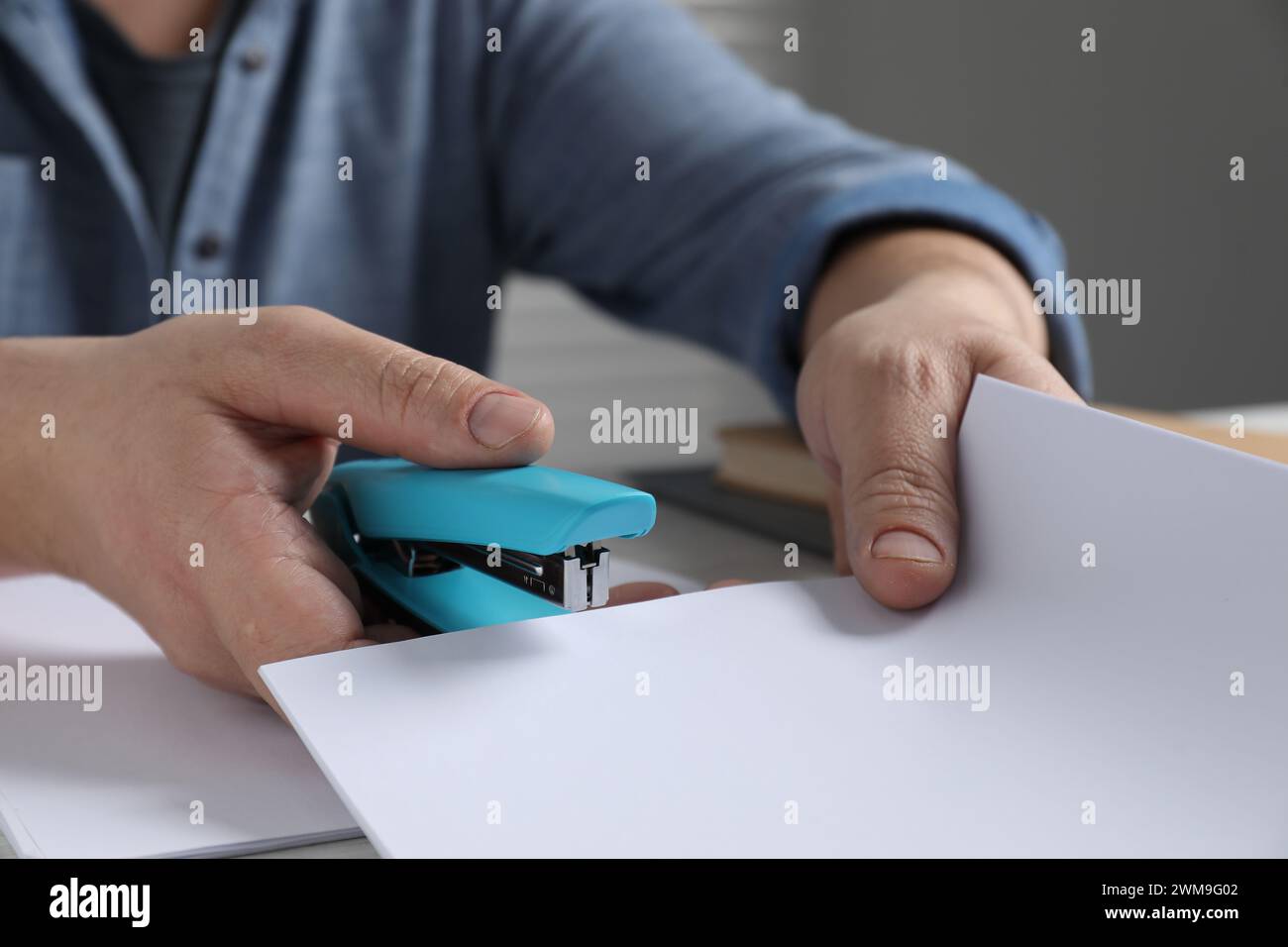 Blue stapler stapling papers hi-res stock photography and images - Alamy