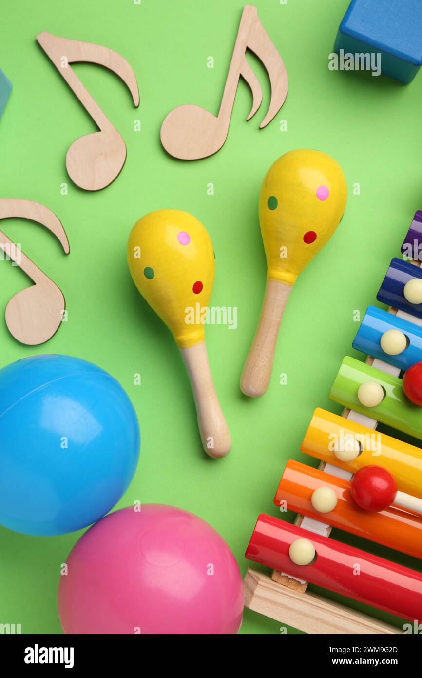 Tools for creating baby songs. Flat lay composition with maracas on green background Stock Photo ...