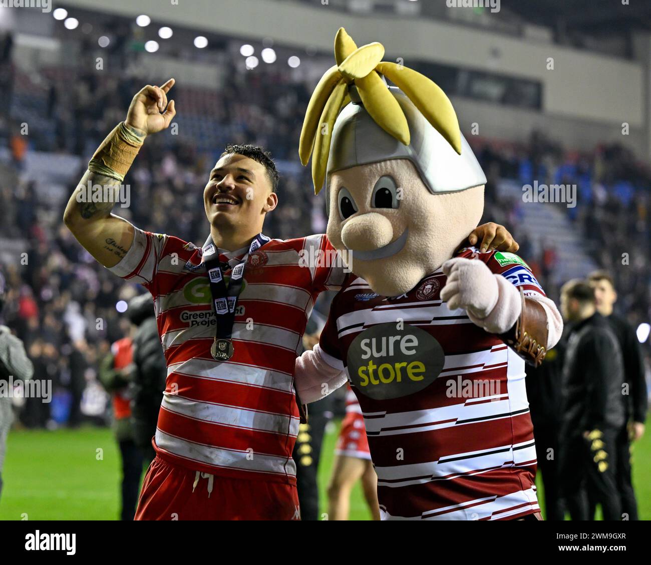 Patrick Mago of Wigan Warriors celebrates with Mighty Max mascot of ...