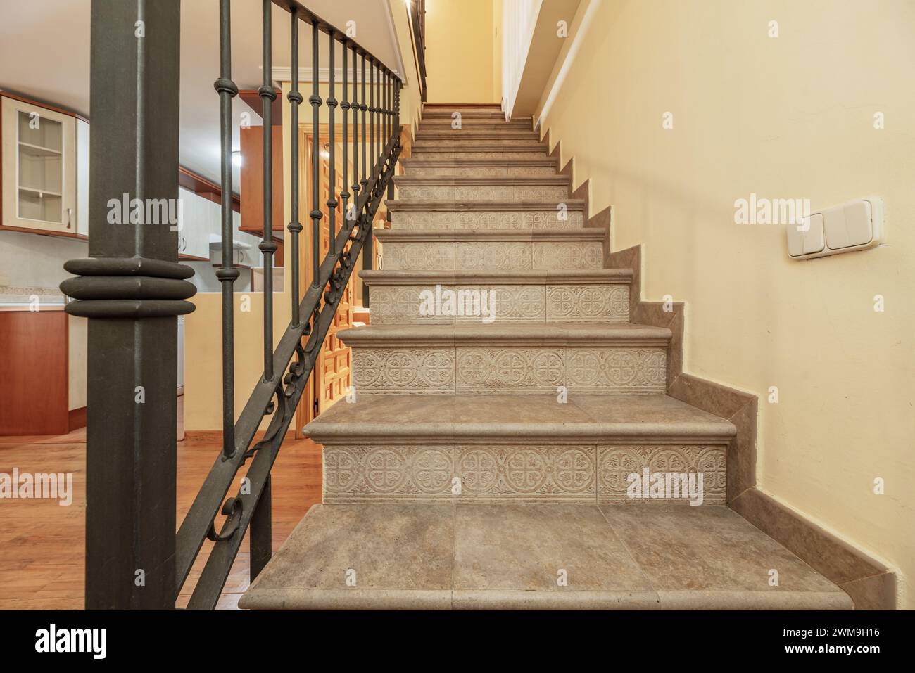Interior stairs of a duplex residential home with steps with gray tiles ...