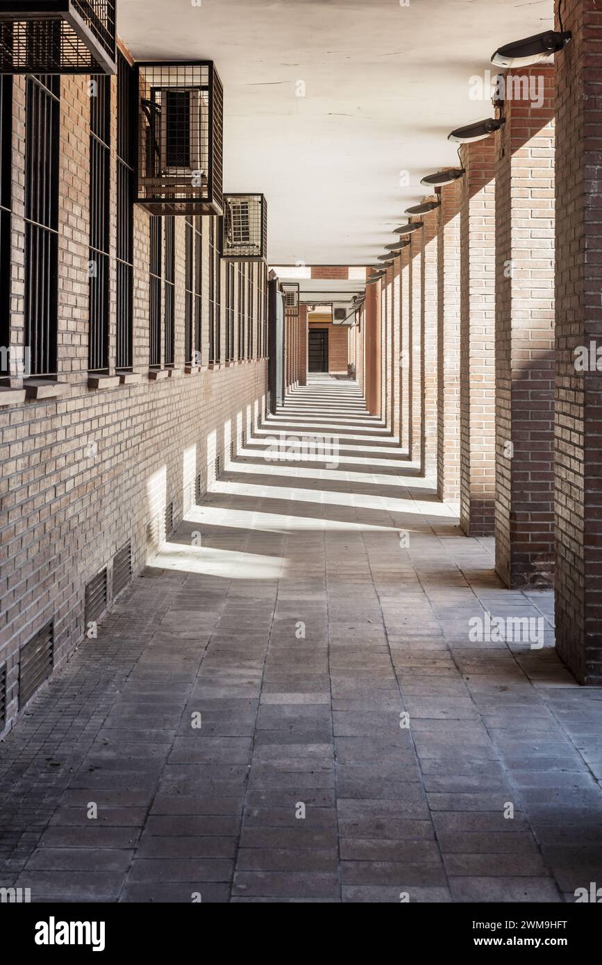 Passage in the basement of a building with shadows of the pillars ...