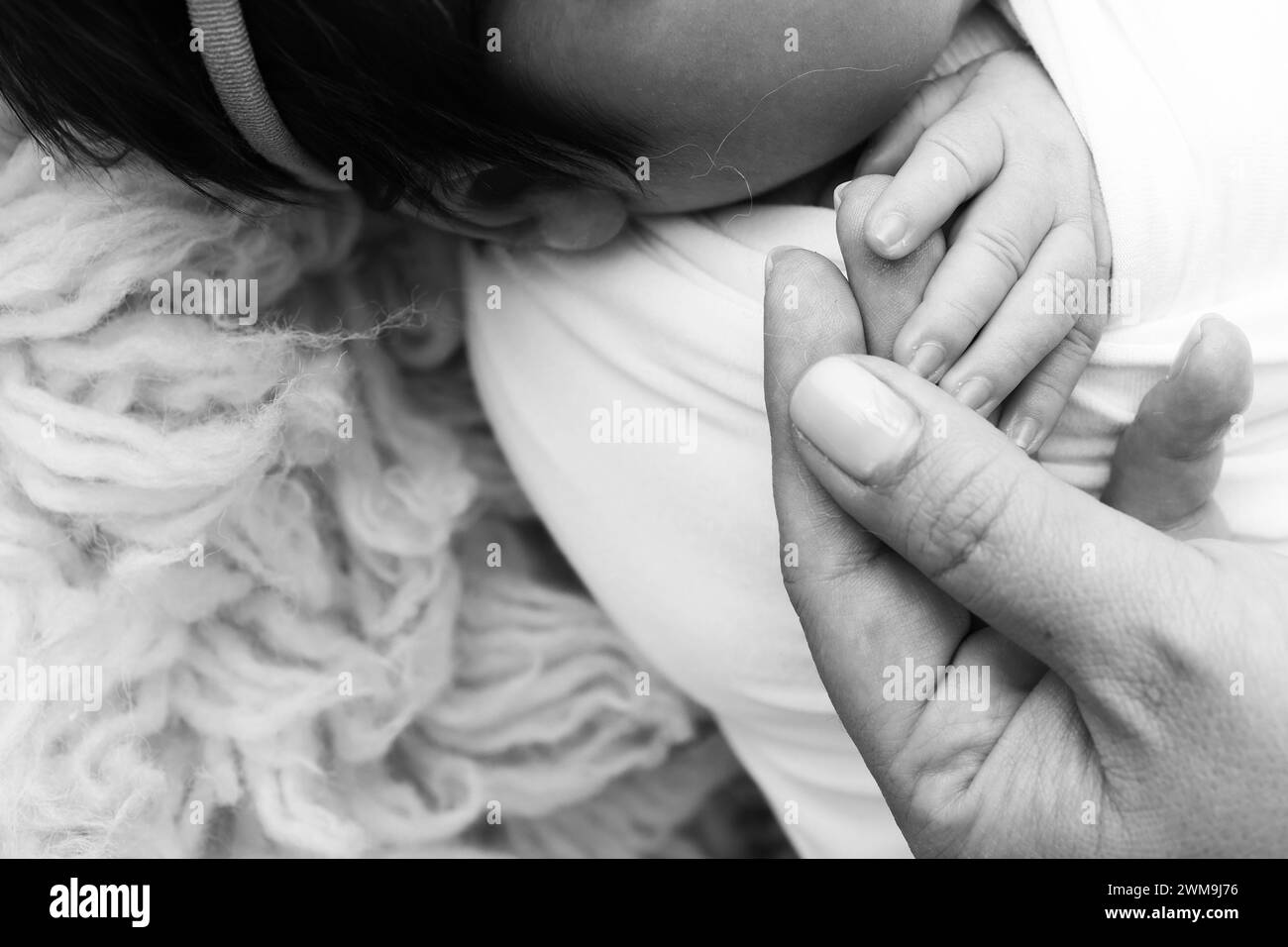 Black and white Photo of Newborn baby after birth tightly holding ...