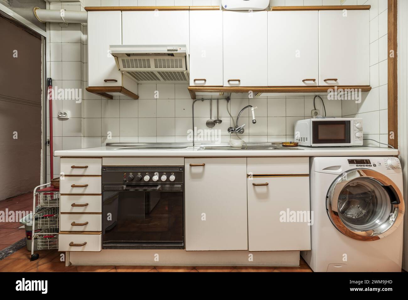 Front image of kitchen furnished with antique white furniture with ...
