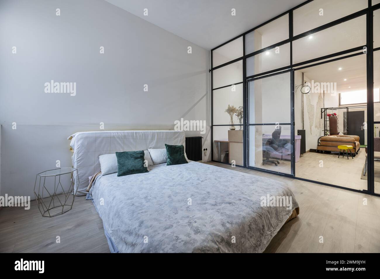 Half empty room with a metal frame wall with transparent panels and a ...