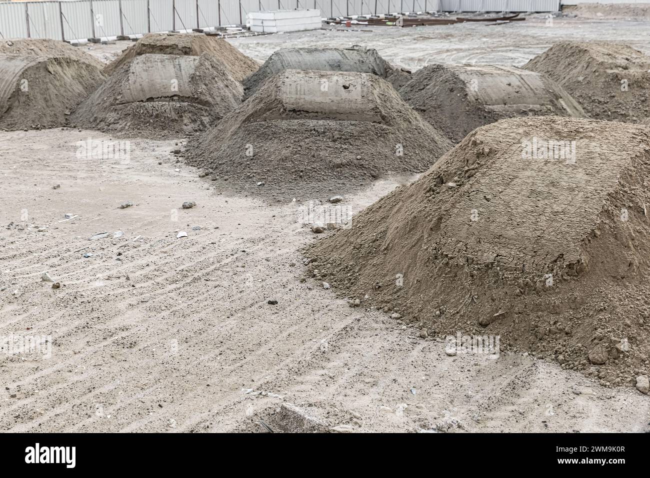 Piles of soil from the desert at a construction site of a new house in ...