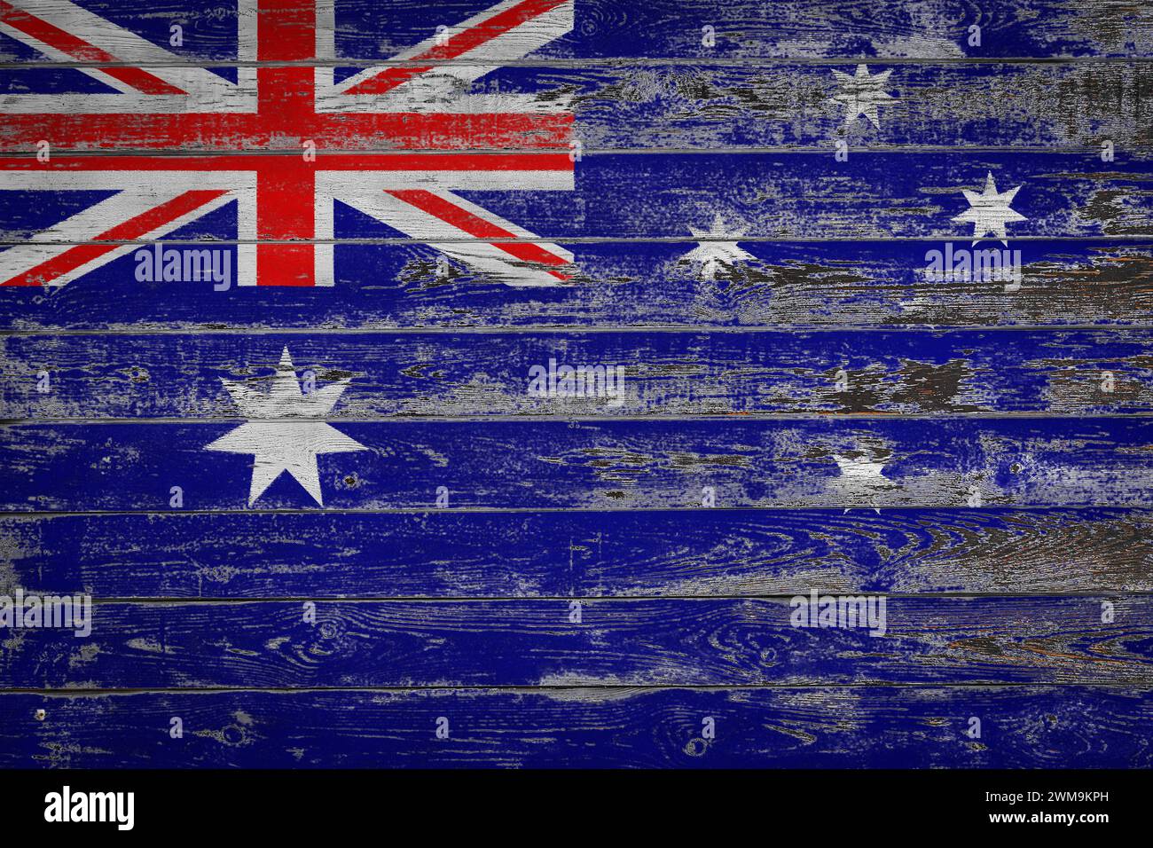 The national flag of Australia is painted on uneven wooden boards ...
