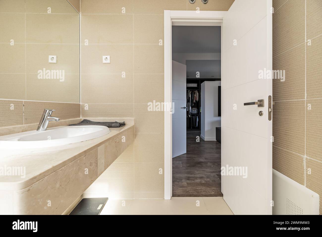 Bathroom with porcelain sink embedded in a marble countertop and a ...