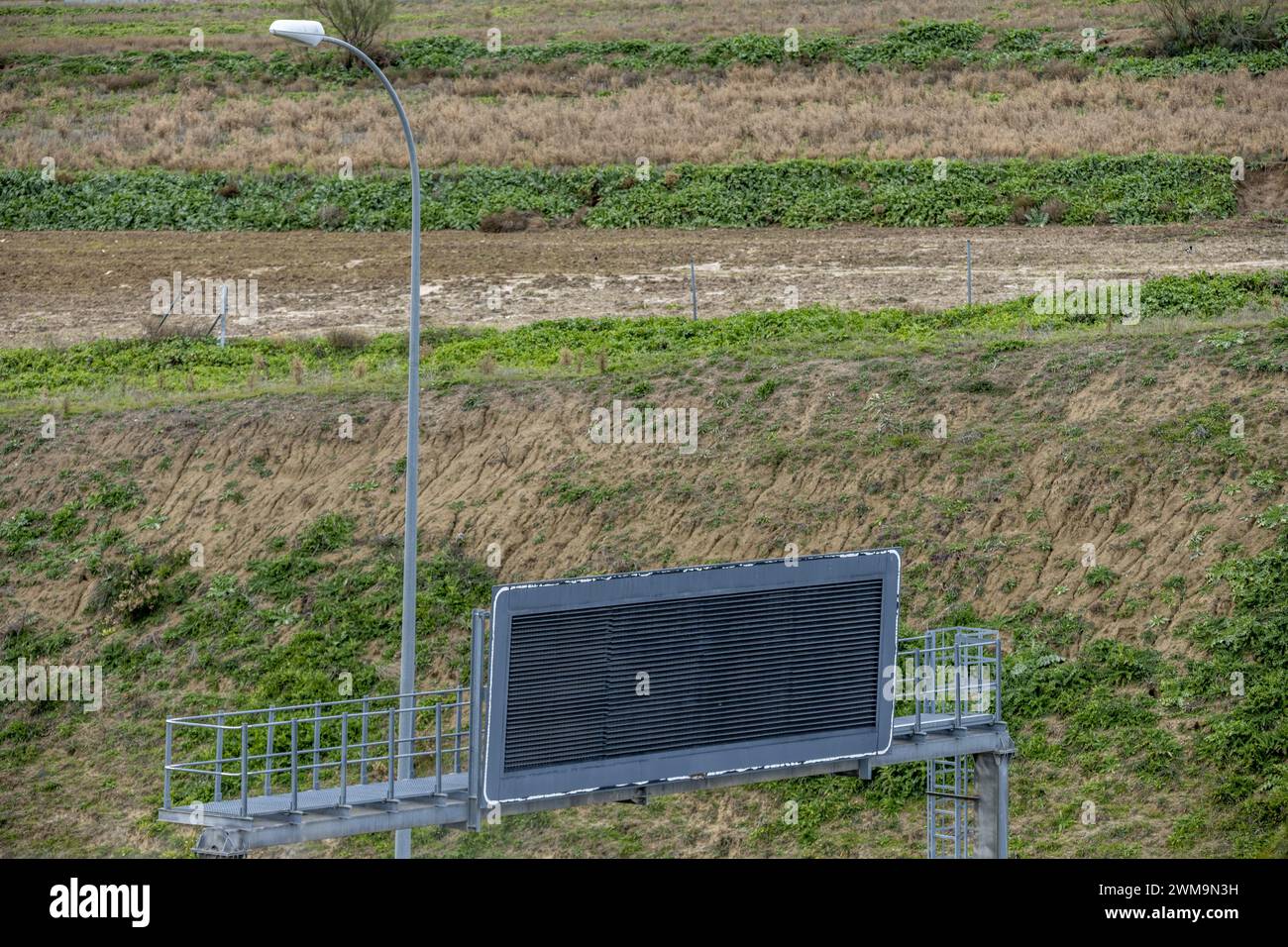 A bright traffic warning sign on its metal structure with railings for ...