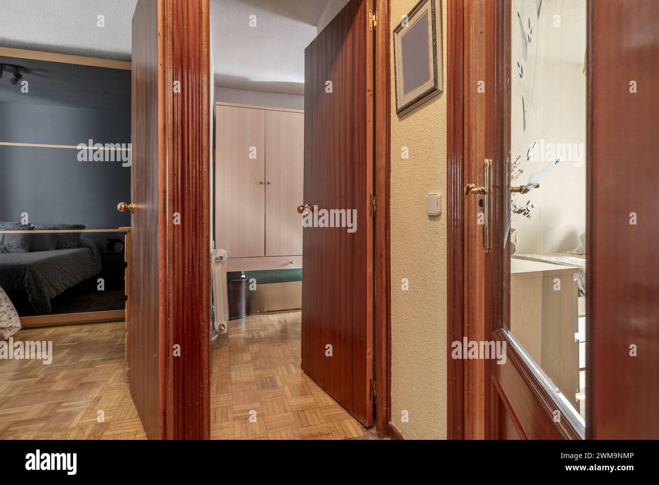 Distributor of a home with simple sapelly wood doors Stock Photo - Alamy