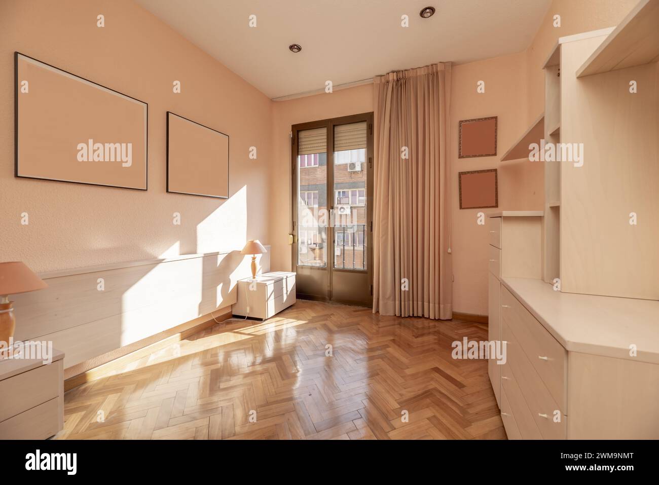 Bedroom of a house with furniture and white headboard without bed in a ...