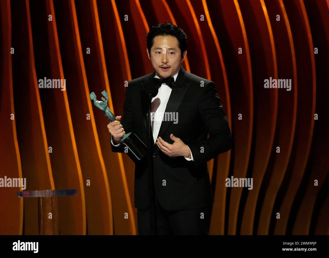 Steven Yeun accepts the award for outstanding performance by a male ...