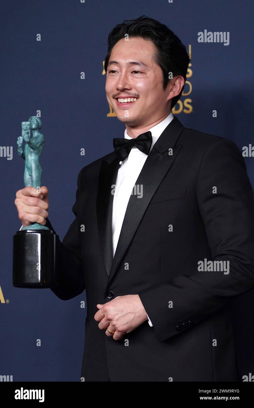 Steven Yeun poses in the press room with the award for outstanding ...