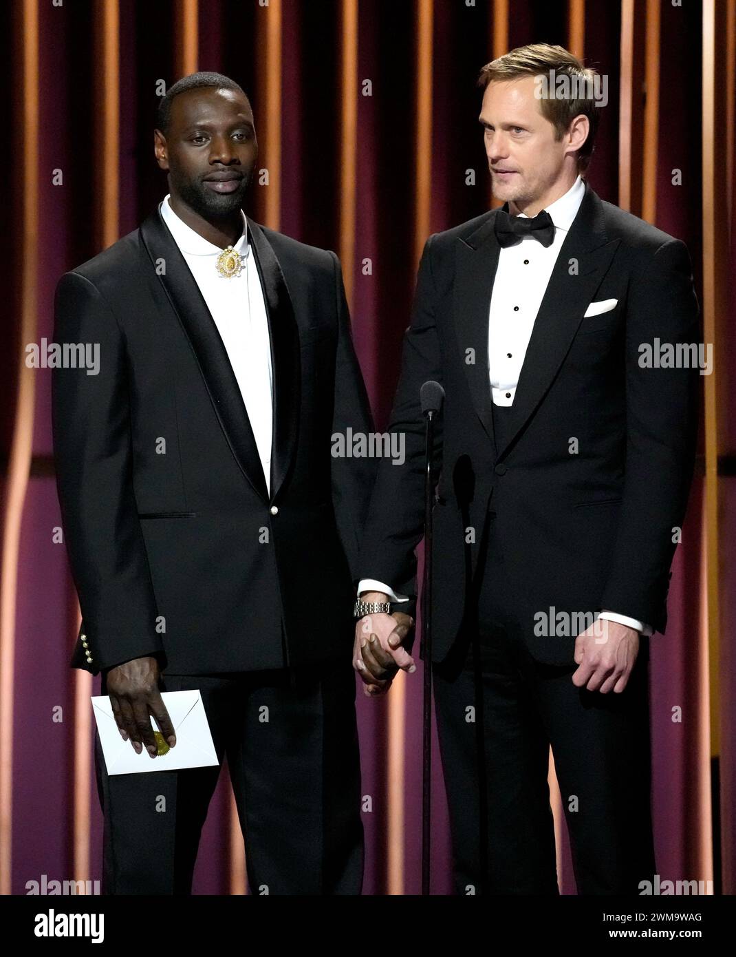 Omar Sy, left, and Alexander Skarsgard present the award for ...