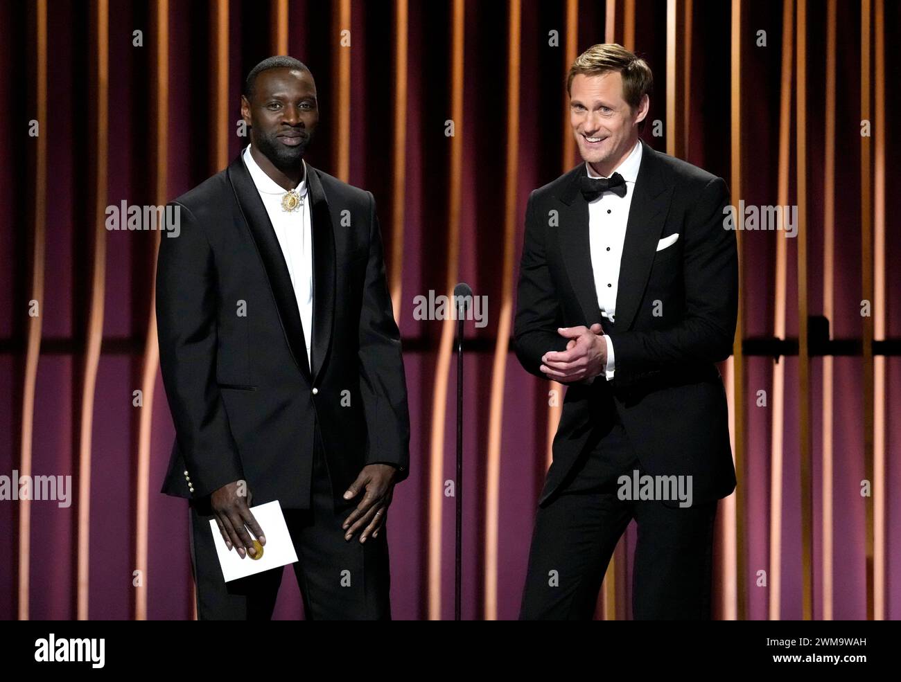 Omar Sy, left, and Alexander Skarsgard present the award for ...