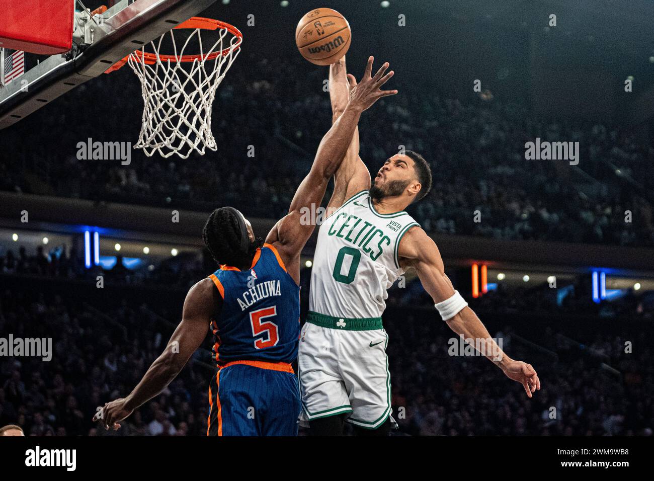 Boston Celtics forward Jayson Tatum (0) attempts a dunk over New York Knicks forward Precious ...