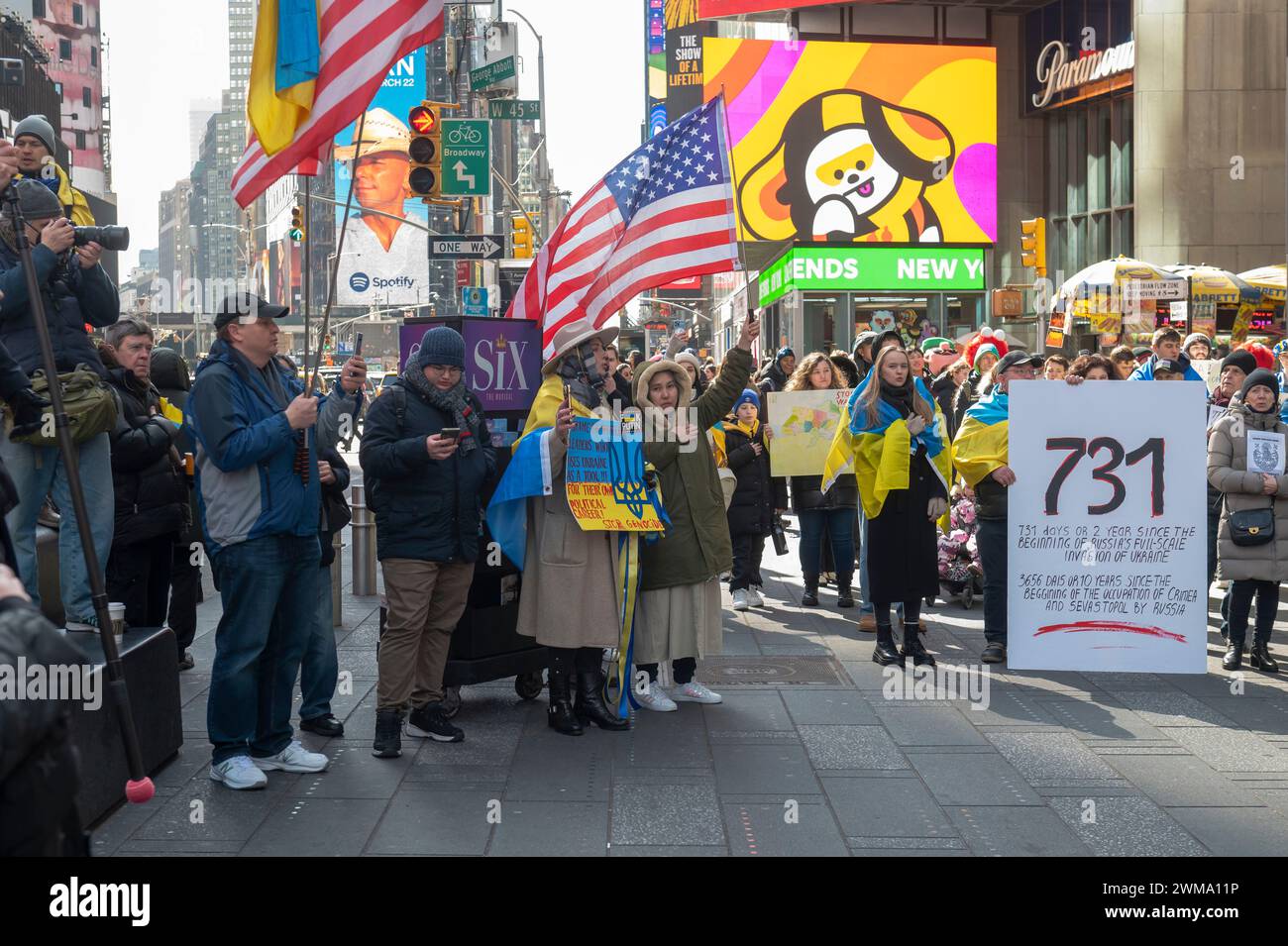NEW YORK, NEW YORK - FEBRUARY 24: People hold signs and flags at a ...