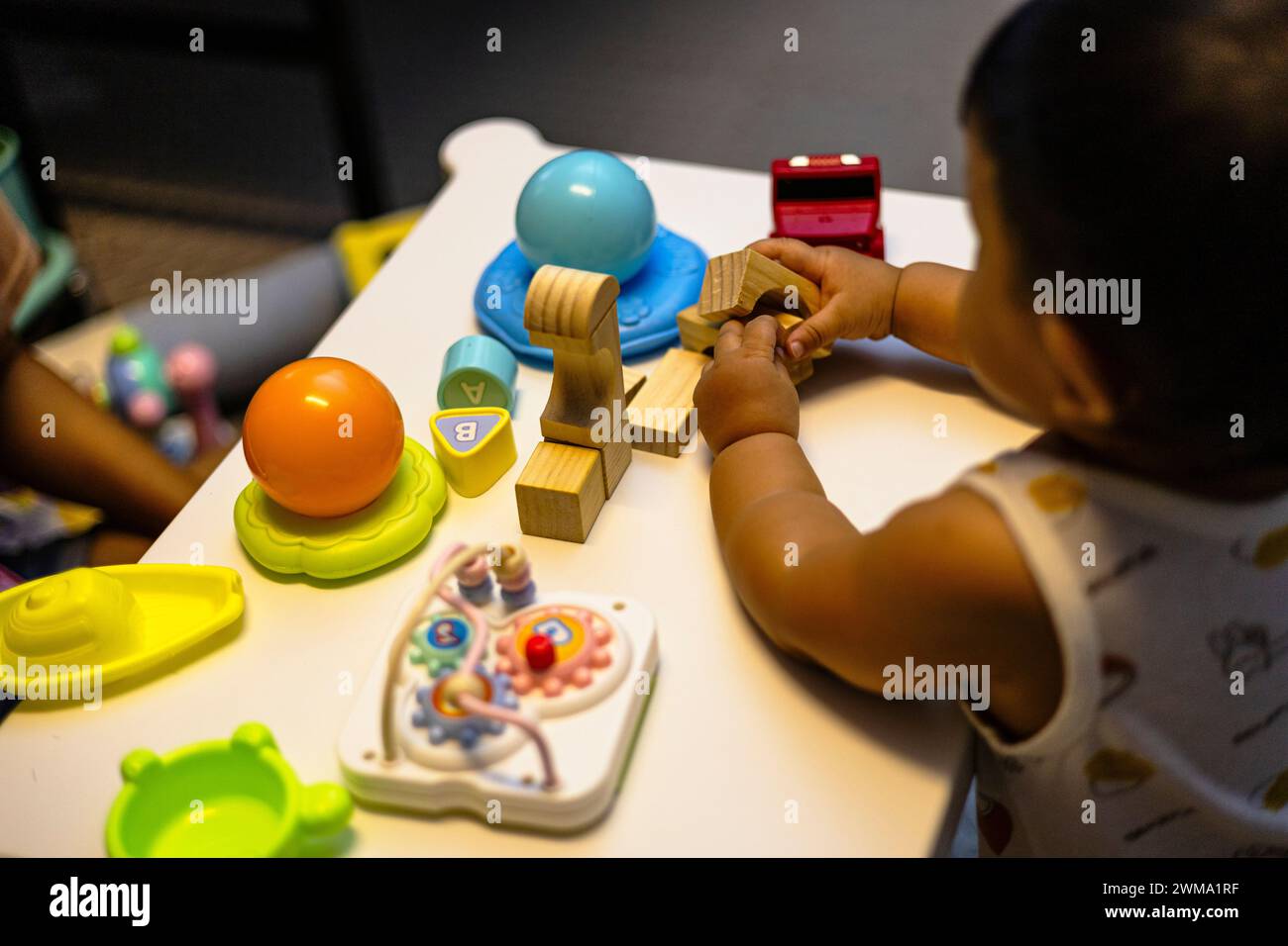 Asian baby Toddler playing colorful blocks Stock Photo - Alamy