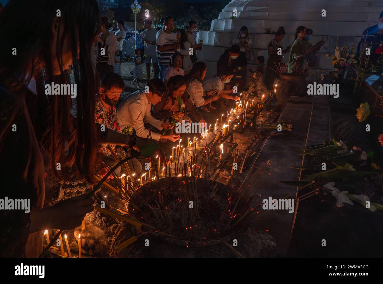 Local people and Buddhist monks celebrating the Magha Puja full moon ...