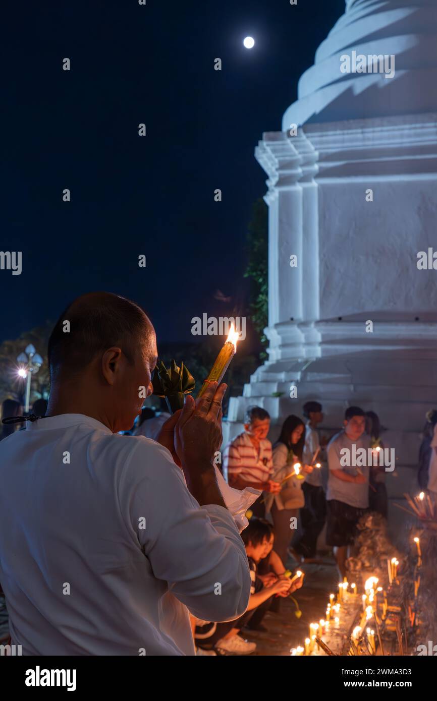 Local people and Buddhist monks celebrating the Magha Puja full moon ...