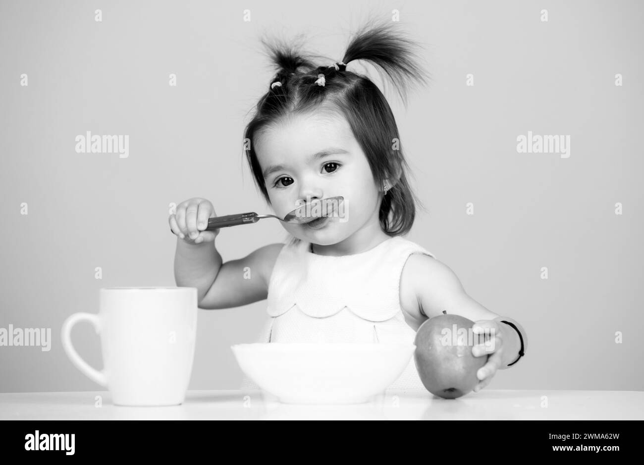 Cute baby food, babies eating. Kid eating healthy food with a spoon at ...