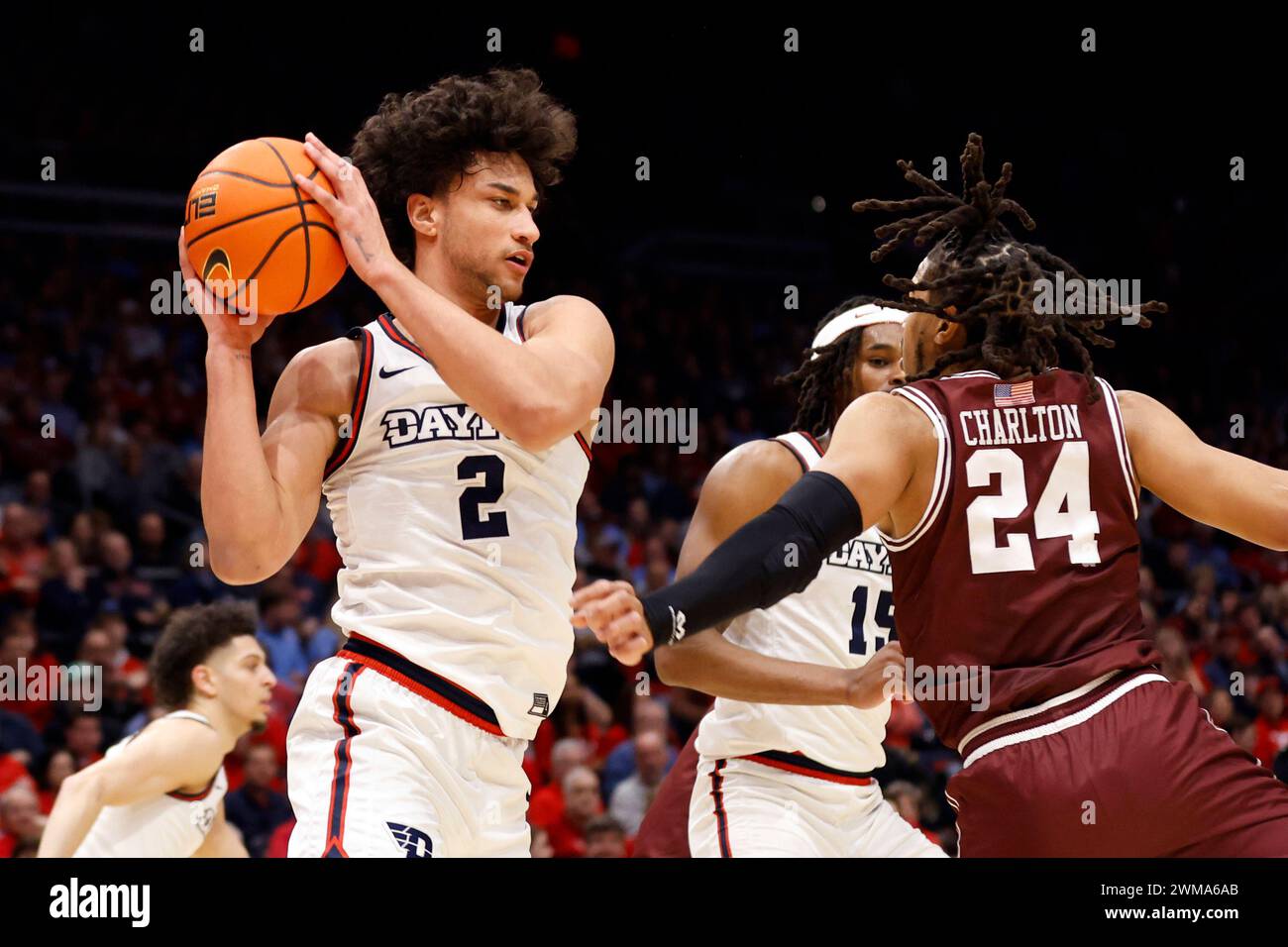 Dayton forward Nate Santos, left, grabs a rebound in front of Fordham ...