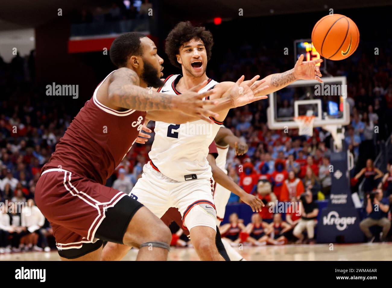 Dayton forward Nate Santos, right, passes in front of Fordham guard ...