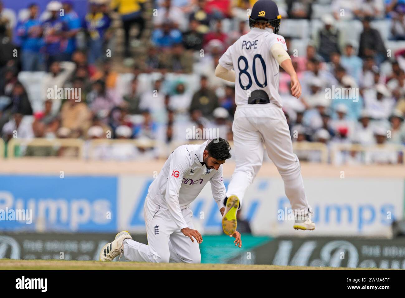England's Shoaib Bashir, left, kneels as he celebrates the wicket of ...