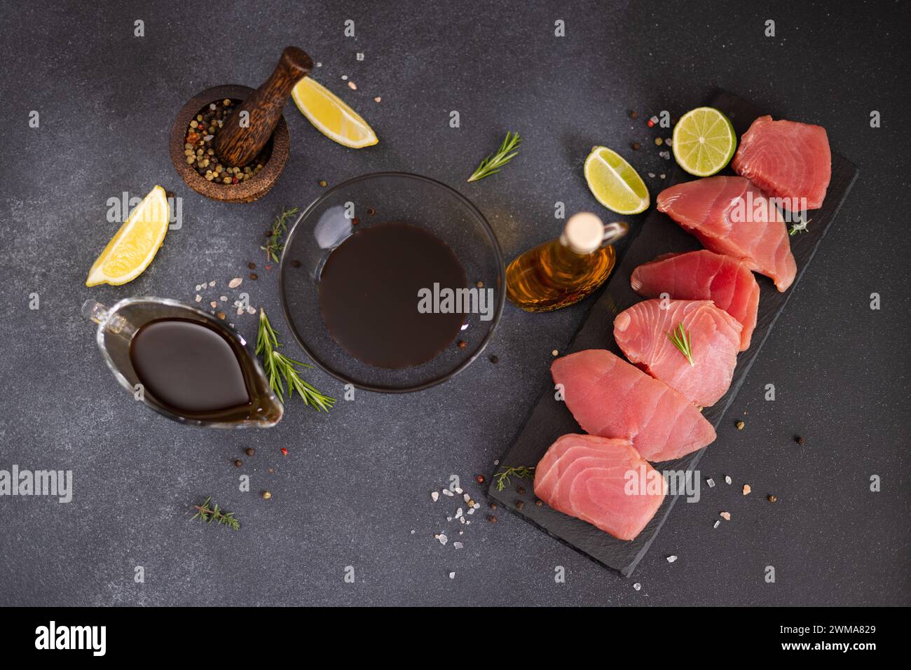 Pieces of Fresh tuna Fish fillet and soy sauce marinade in a glass bowl ...