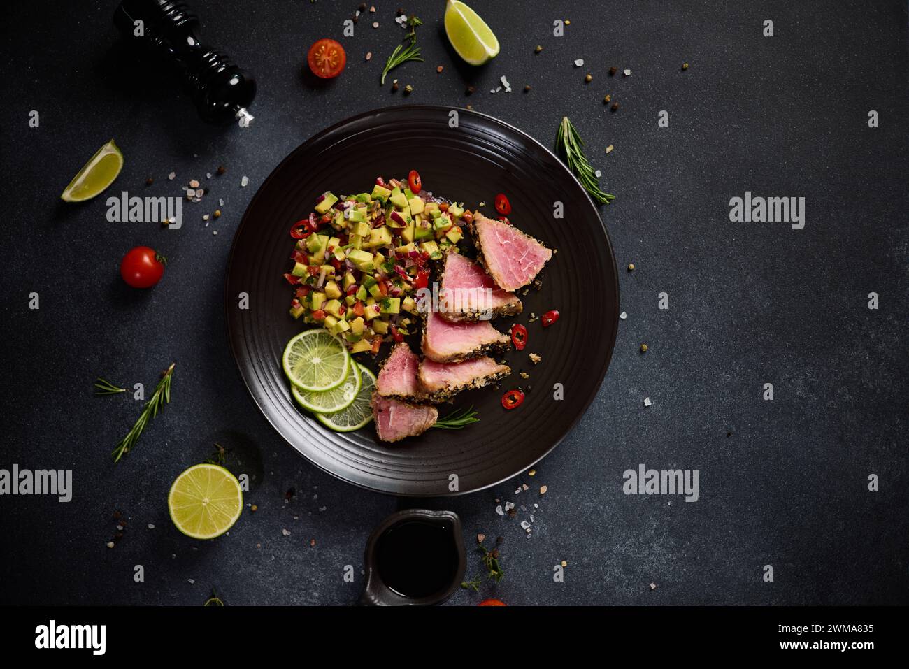 Sliced Organic grilled Tuna fillet covered with sesame seeds and salsa ...