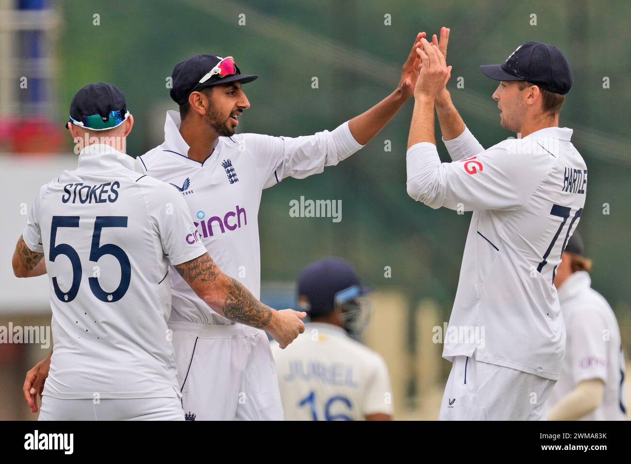 England's Tom Hartley, right, and Shoaib Bashir, center, celebrate at the end of India's innings ...
