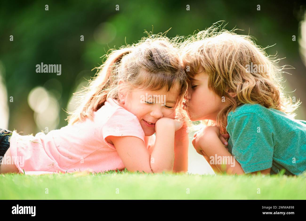 Child boy and girl hugging each other with love in the spring garden ...
