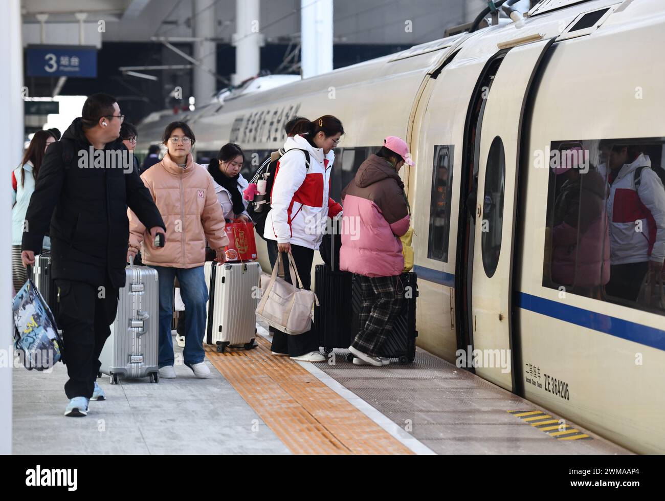 FUYANG, CHINA - FEBRUARY 25, 2024 - Passengers take a train at Fuyang ...