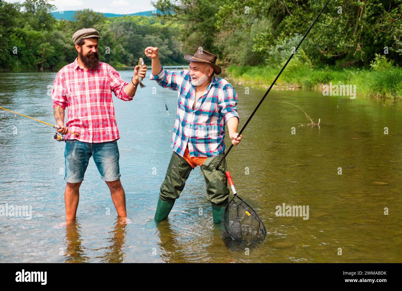 Fisherman men friends and trophy trout. Father and son fishing ...