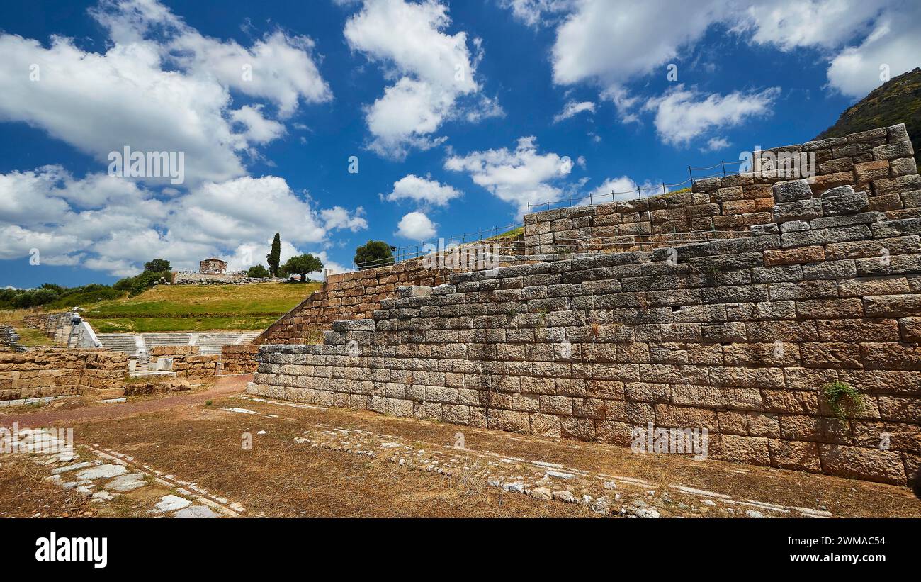 Historic remains of ancient walls against a cloudy sky and green ...