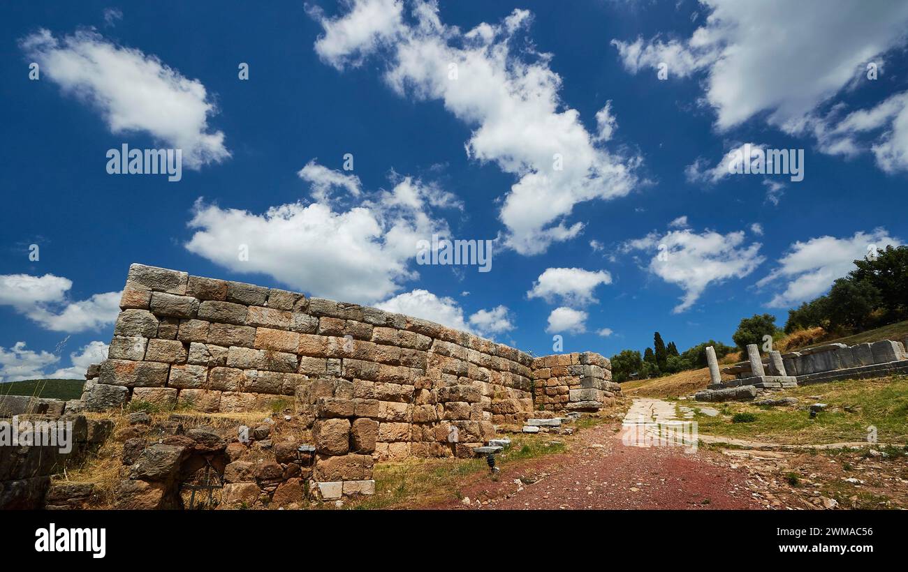 Path leads to ancient walled ruins under a cloudy blue sky, Ancient ...