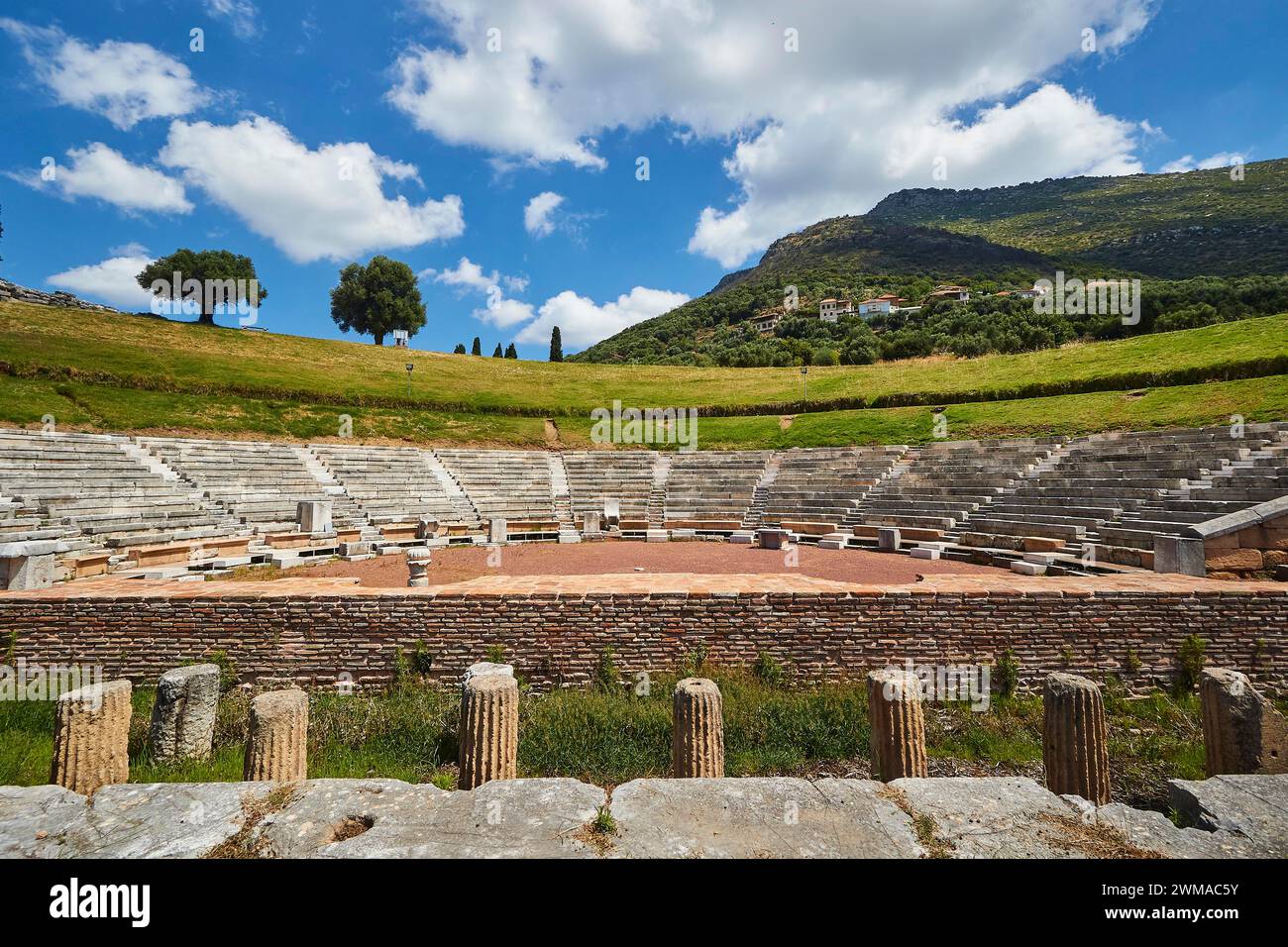 Ancient theatre with semi-circular rows of seats and stage, surrounded ...