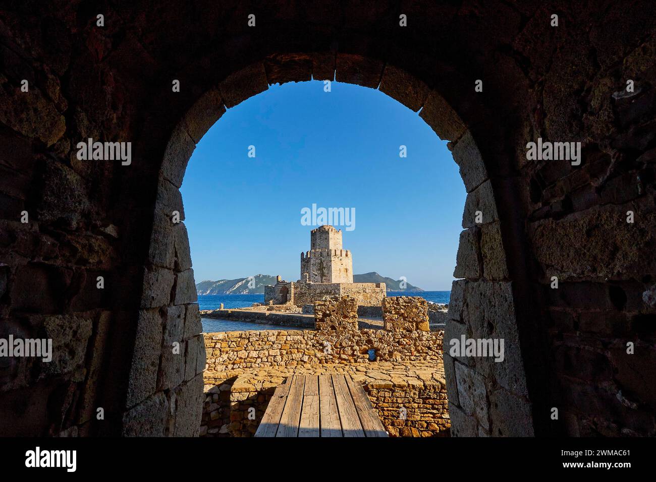 View through an arched entrance to a castle by the sea, octagonal ...