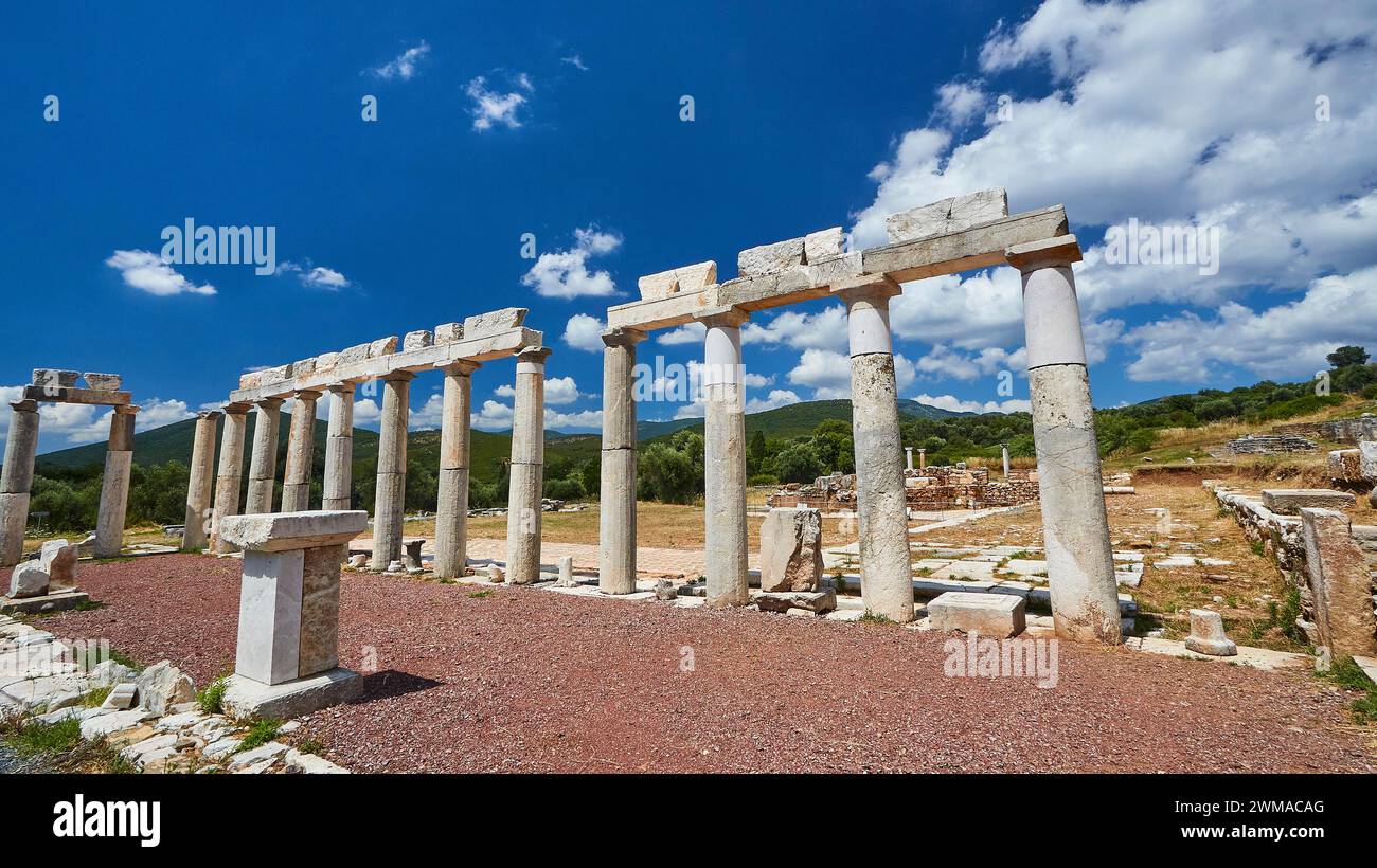 Row of ancient columns under a bright blue sky on an archaeological ...