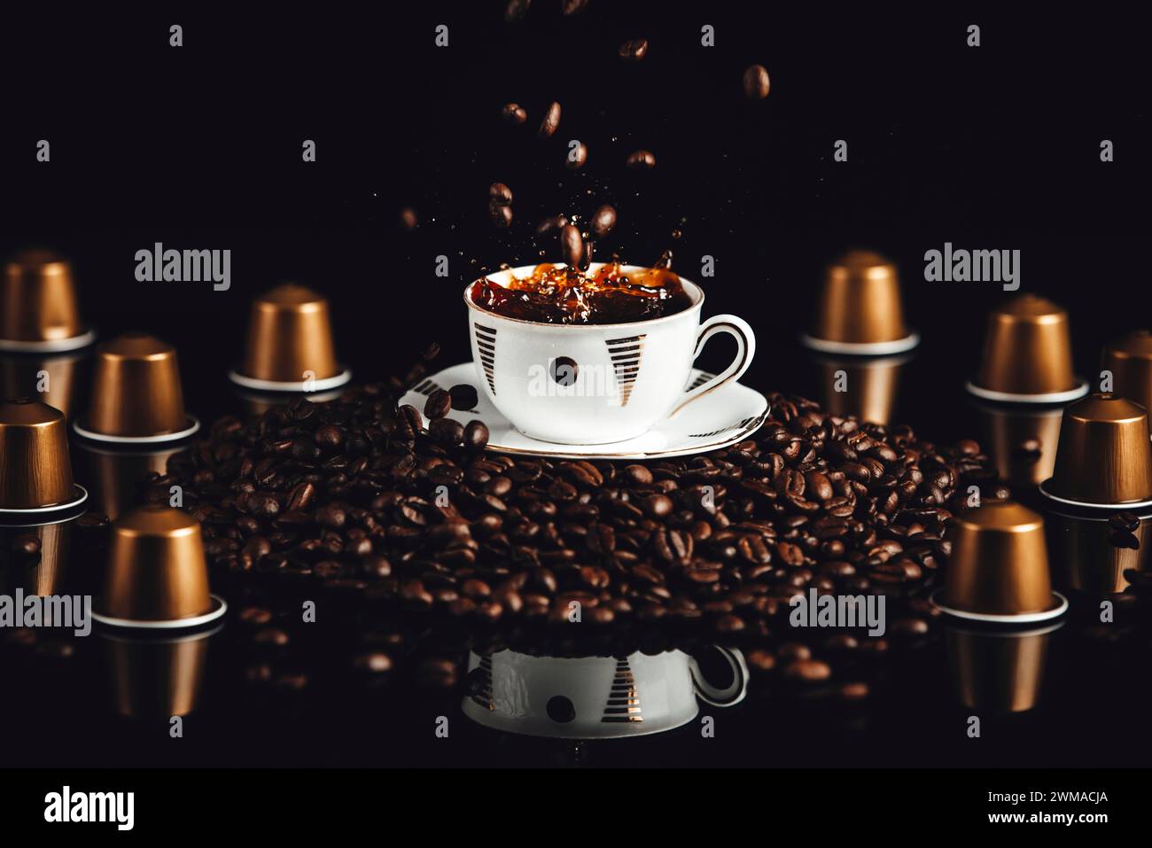 Coffee cup on coffee beans with falling beans and splashes, coffee ...