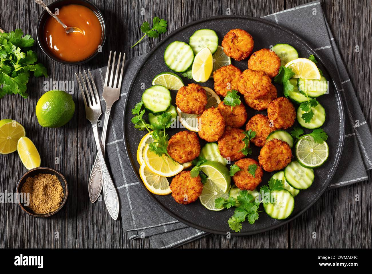 fried rice patties, rice tikki, indian style on black plate served with ...