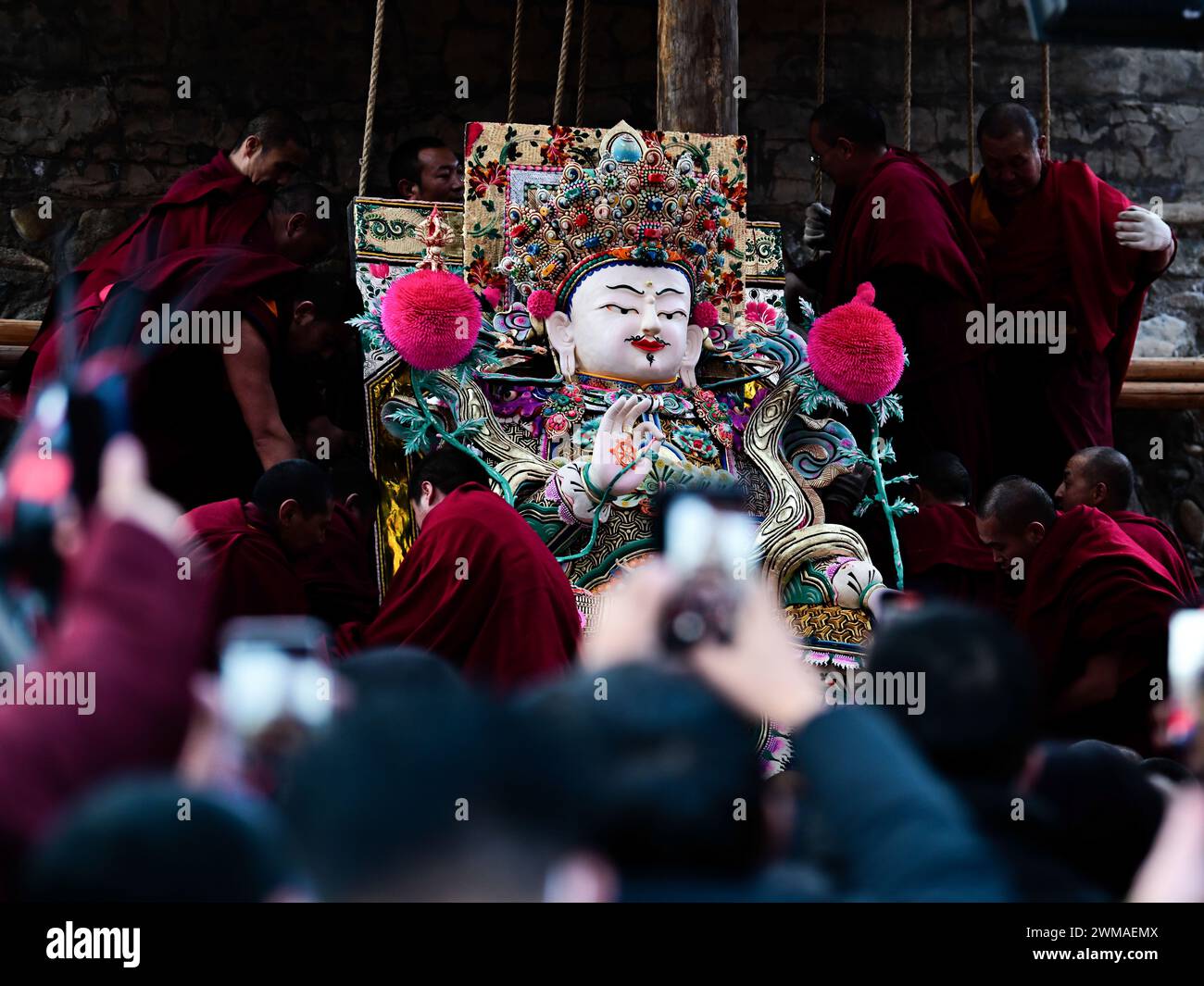 Xining, China's Qinghai Province. 24th Feb, 2024. Lamas carry a butter ...