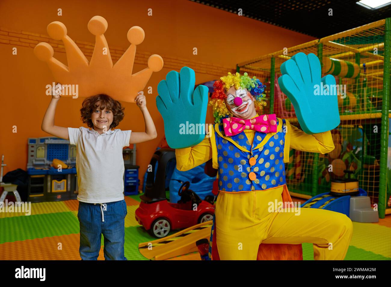 Happy boy child and funny clown posing for camera while playing ...