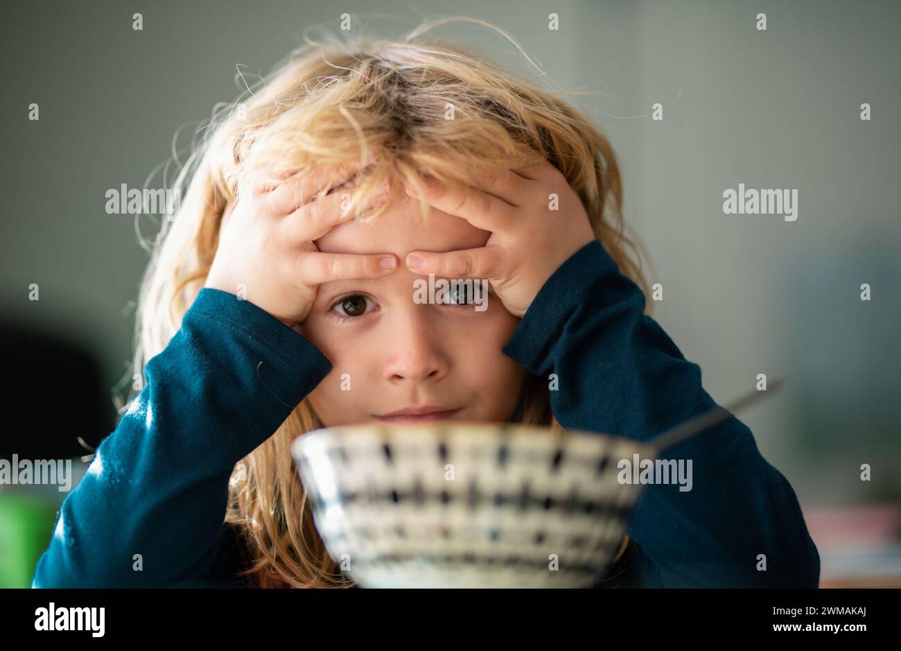 Child have a breakfast. Sad boy eating healthy chicken noodle soup for ...