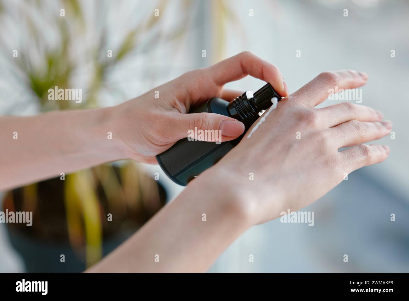 Closeup woman applying hand lotion from natural SPA cosmetics Stock ...