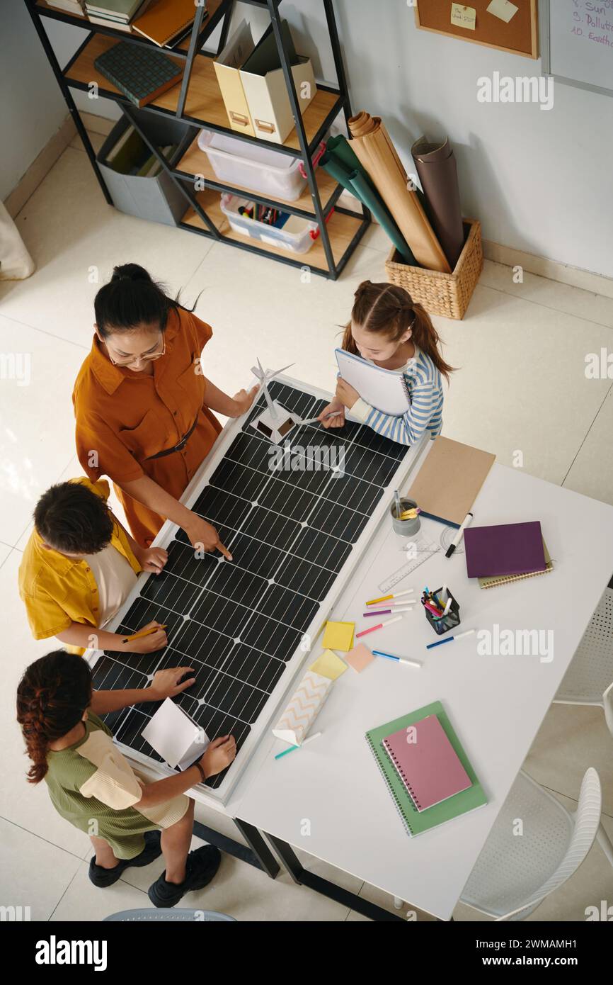 Teacher explaining kids how cells of solar panel work, top view Stock ...