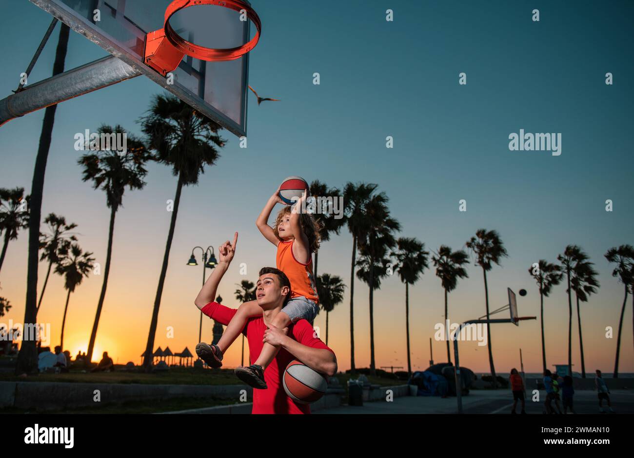Basketball training kid boy with coach, kid boy throwing ball in ...
