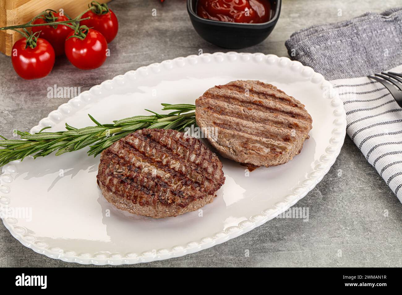 Grilled two beef burger cutlet served rosemary Stock Photo - Alamy