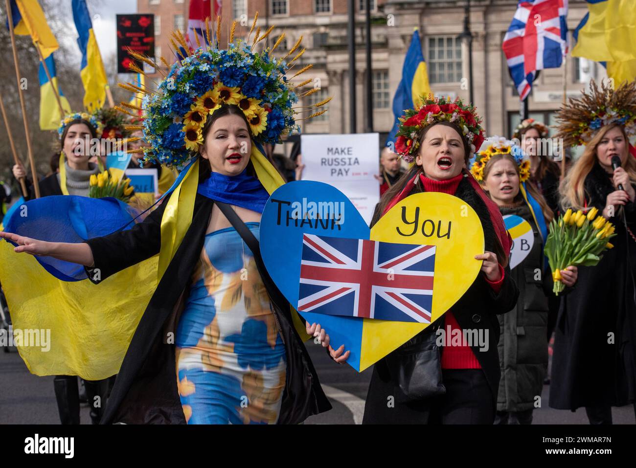 London, UK. 24th Feb, 2024. Protesters are holding a heart with a ...