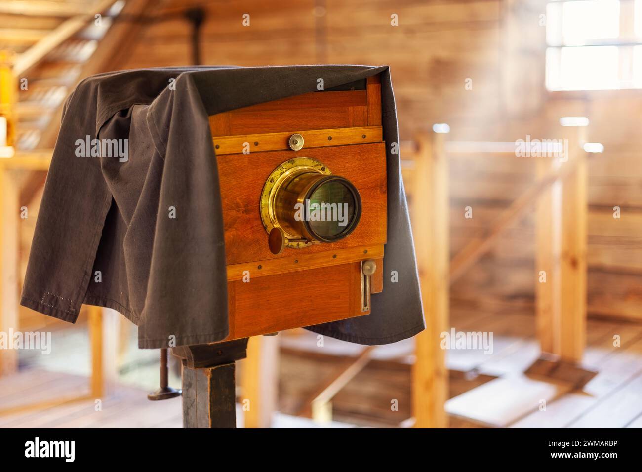 Old retro vintage large wooden photo camera in sunshine wooden room ...